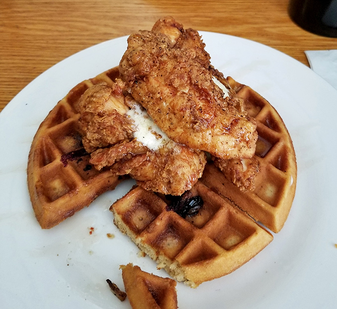 The star of the show: golden-brown chicken perched atop a perfectly cooked waffle. This isn't just breakfast-meets-dinner; it's a culinary love story.