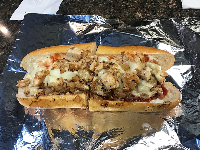 Behold the star attraction! Chunks of grilled chicken nestled in melted cheese create a sandwich that makes beef lovers question their loyalty.