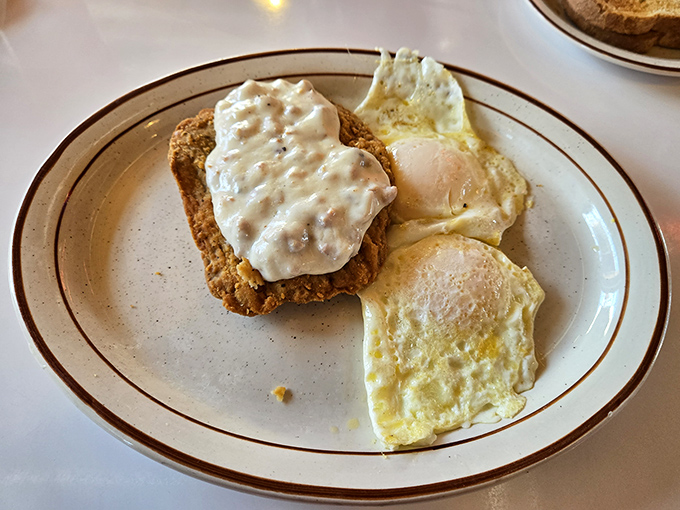 The star of the show: chicken fried steak with creamy gravy and sunny-side-up eggs. Comfort food that hugs your soul before it hugs your arteries.