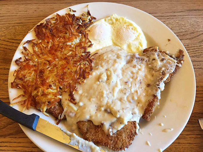 This chicken fried steak doesn't just come with gravy&mdash;it's having a passionate love affair with it, while those crispy hash browns stand by as willing accomplices.