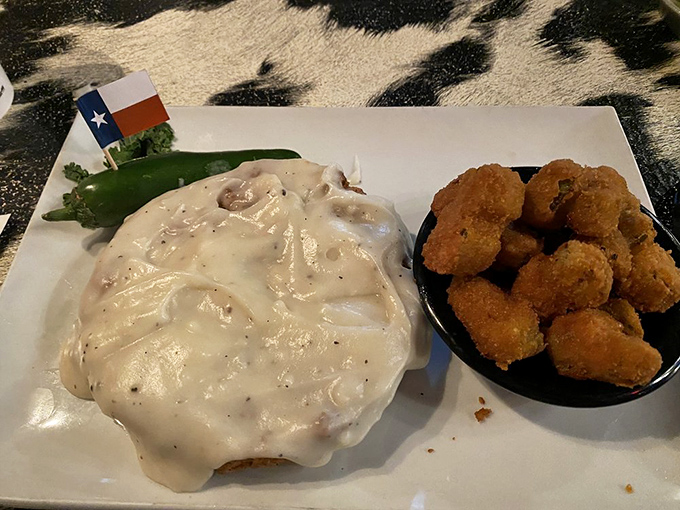 Behold the chicken fried steak in its natural habitat&mdash;swimming in creamy gravy with a Texas flag planted proudly nearby. Comfort food that hugs your soul.