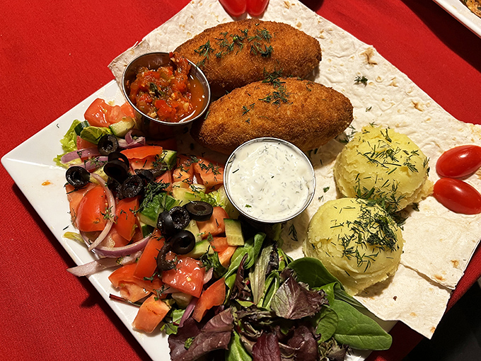 Behold the legendary Chicken Kyiv - golden perfection that flows with herbed butter magic.