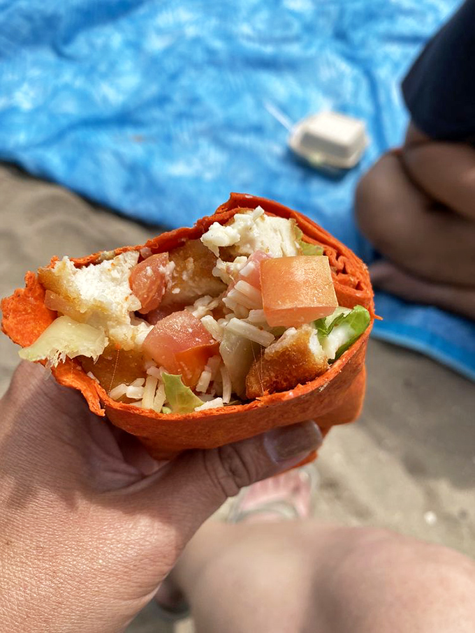 This isn't your sad desk lunch wrap. Vibrant veggies and tender chicken nestled in a sunset-colored tortilla &ndash; beach dining that doesn't sacrifice flavor for portability.
