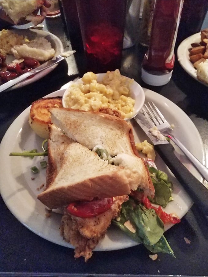 That's not just a sandwich; it's architecture with purpose. Load-bearing toast supports a masterpiece of savory fillings and mac and cheese.