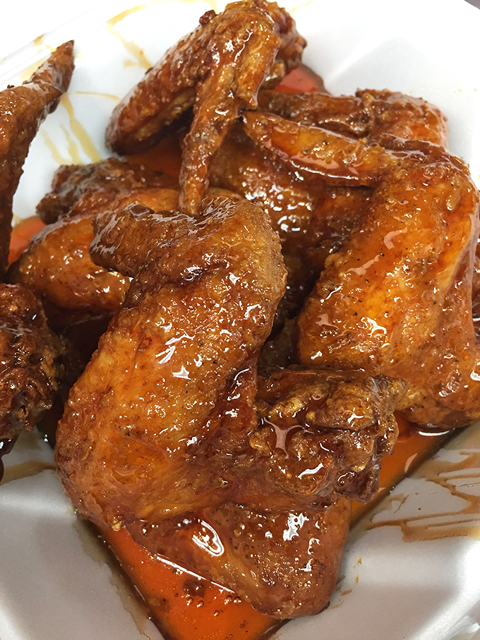 These glistening, sauce-drenched wings aren't just food&mdash;they're a religious experience. Each one perfectly crisp outside, juicy inside, like chicken wing nirvana.