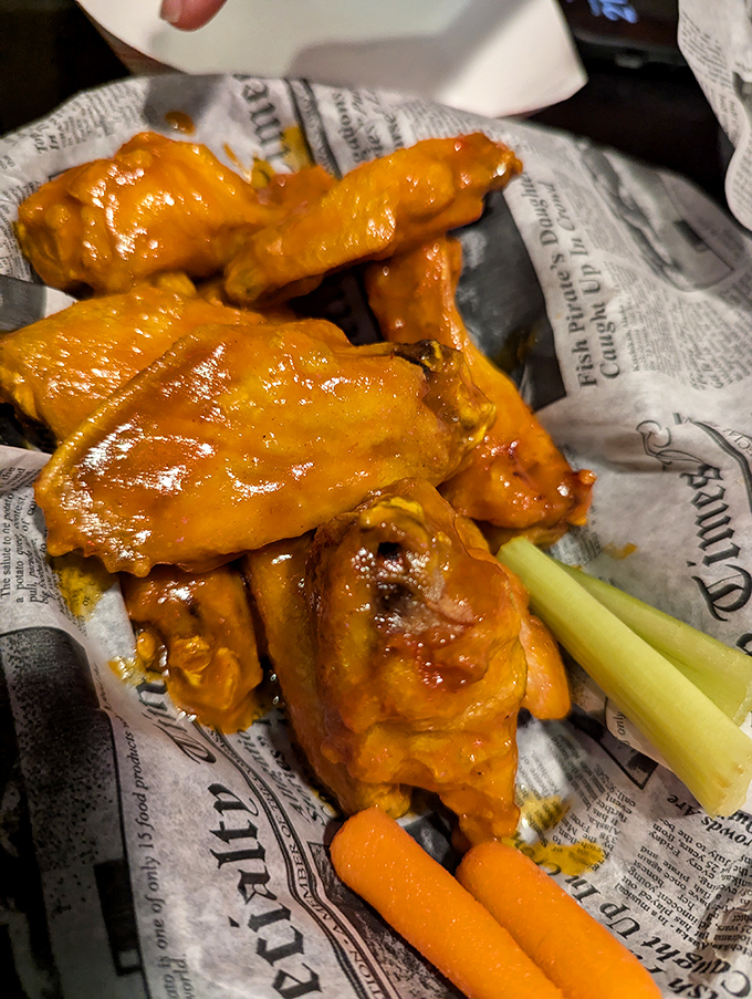 These wings aren't just orange&mdash;they're practically glowing with flavor potential. Served with celery sticks for that token nod to vegetable responsibility.