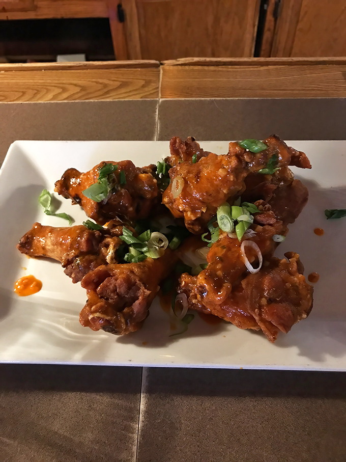 These aren't just wings; they're crispy, saucy masterpieces garnished with green onions. The kind that make you forget napkins exist until it's way too late.