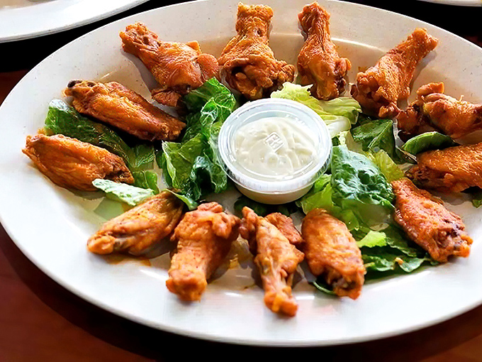 Golden-brown wings arranged like a sunburst around blue cheese dressing&mdash;proof that sometimes the simplest presentations deliver the most profound flavors. 