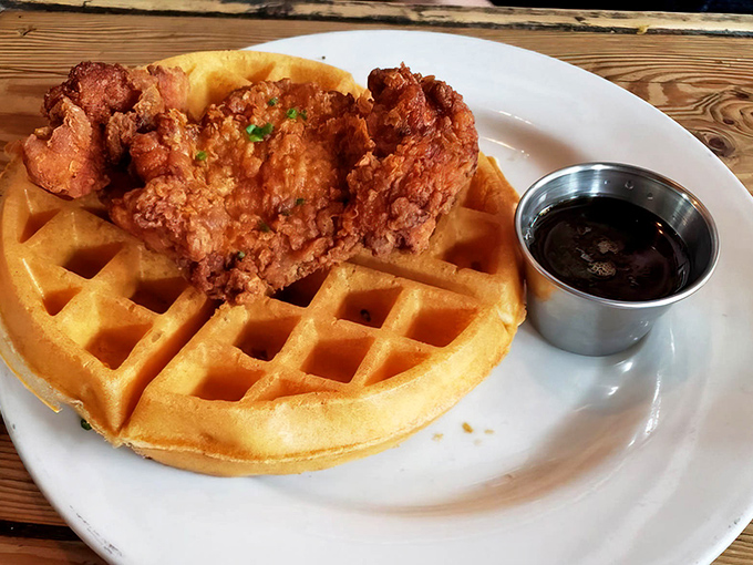 The holy grail of breakfast: golden-brown waffle meets perfectly crispy fried chicken with maple syrup standing by. Resistance is futile.
