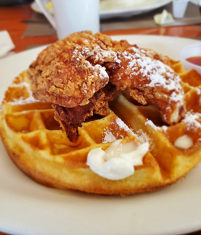 Behold the star attraction: golden-brown waffle meets perfectly crispy chicken in a sweet-savory romance that would make Shakespeare weep.