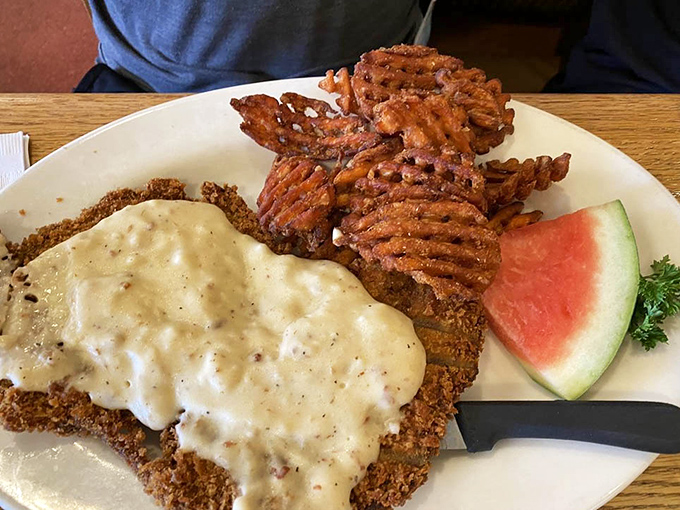 Behold: the chicken fried steak that launched this article. That pepper-flecked country gravy should be classified as a controlled substance.