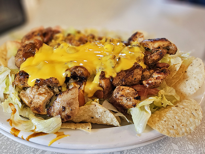 Nachos that don't know the meaning of restraint&mdash;cheese cascading over seasoned chicken like a yellow waterfall of joy. 