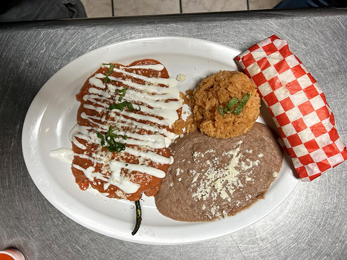 The chile relleno arrives like edible artwork—a perfectly battered poblano pepper drizzled with crema, accompanied by rice that's never an afterthought.