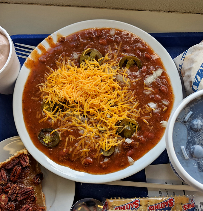 Behold the famous chili in all its glory &ndash; a harmonious blend of savory, spicy goodness topped with a sunshine-yellow crown of shredded cheese.