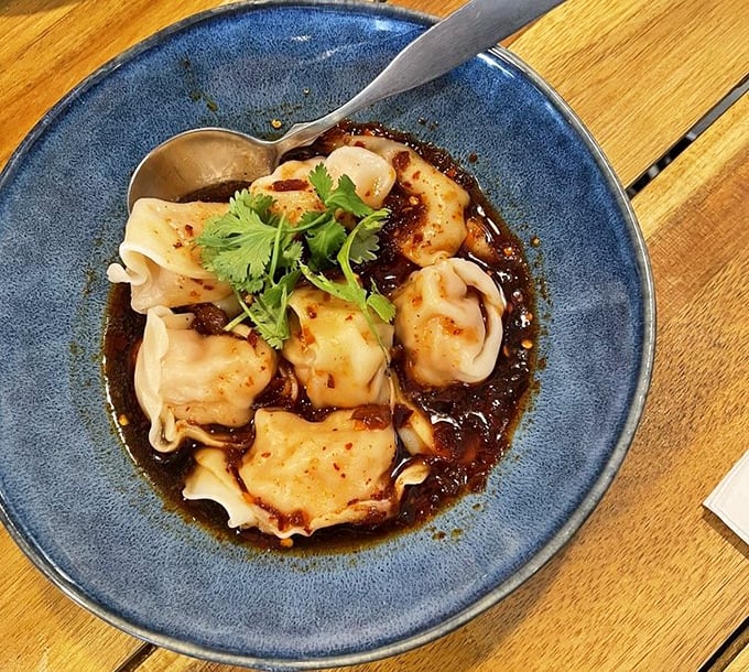 The legendary chili wontons arrive like little gift packages in a pool of complex sauce. One bite and you'll understand why people cross county lines for these.