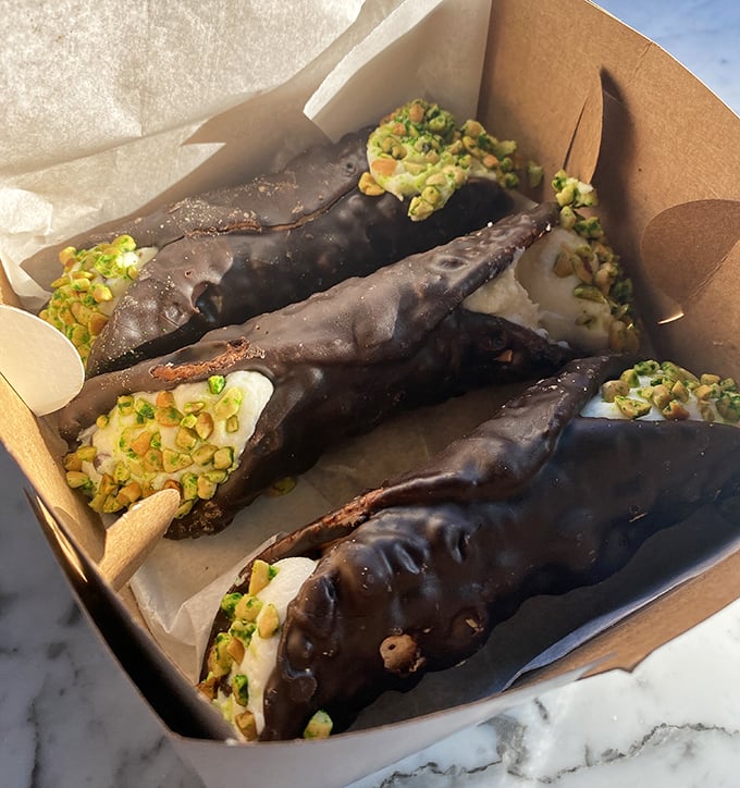 Chocolate-dipped cannoli with pistachio garnish &ndash; the dessert equivalent of putting on a tuxedo. One bite and you'll understand why people cross state lines.