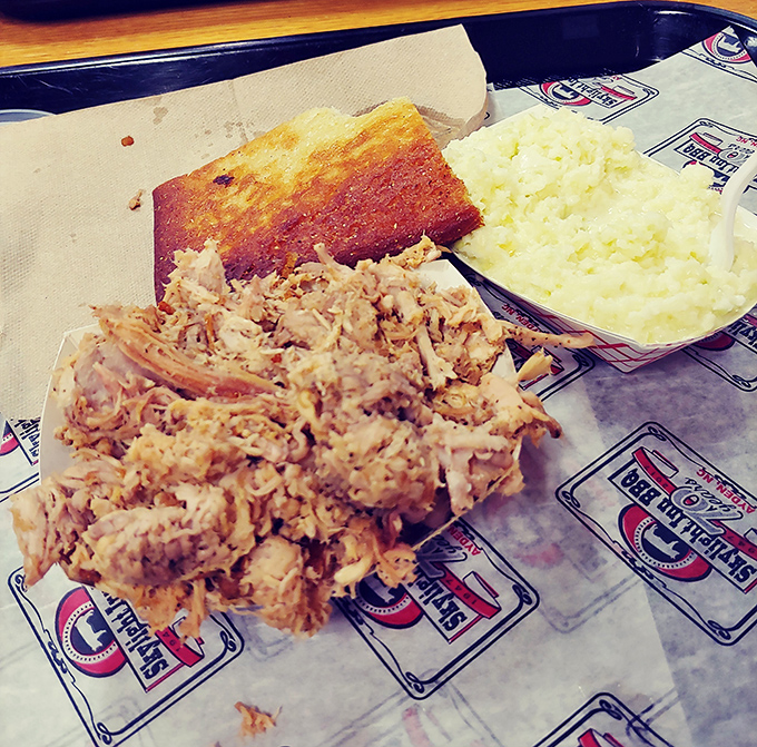 Behold, the holy trinity of Eastern NC barbecue: chopped pork with crackling bits, cornbread that means business, and cooling slaw.