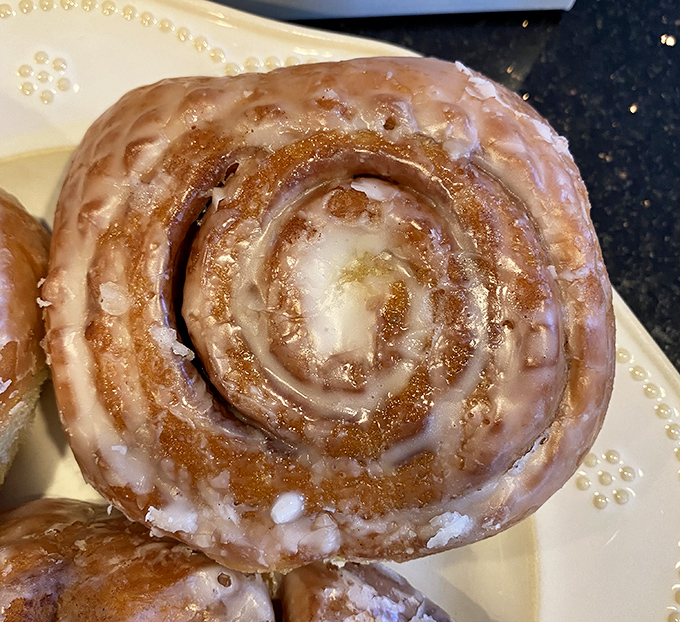 Behold the cinnamon roll in all its glazed glory. This spiral of perfection has caused more spontaneous detours than any GPS recalculation.