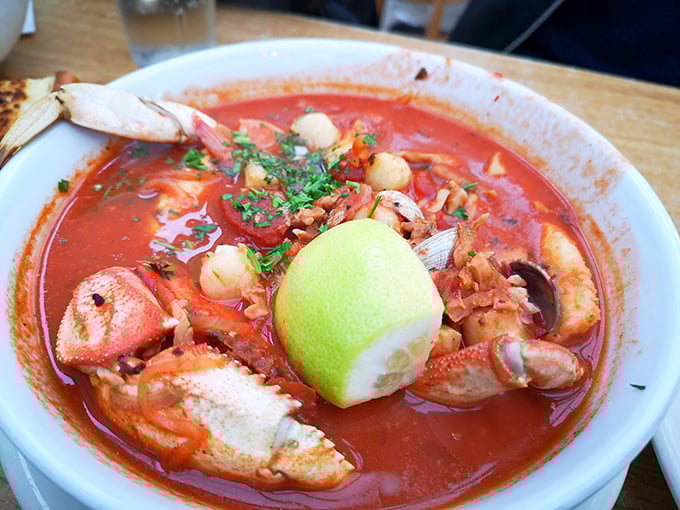 The legendary cioppino arrives like a seafood summit meeting in tomato broth. That lime wedge isn't garnish&mdash;it's the perfect finishing touch to seafood perfection.