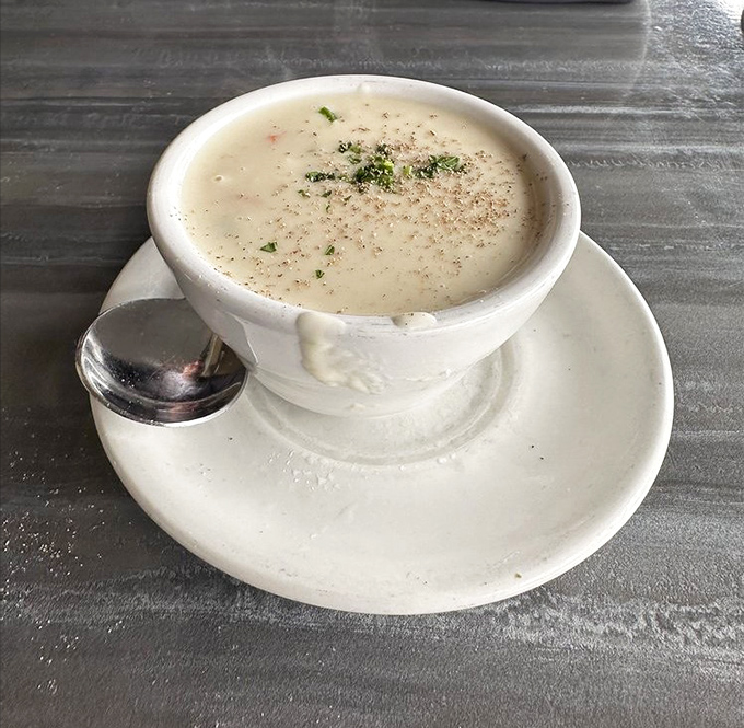 The legendary clam chowder arrives like a silky ocean dream in a bowl, making you wonder if mermaids moonlight as chefs here.