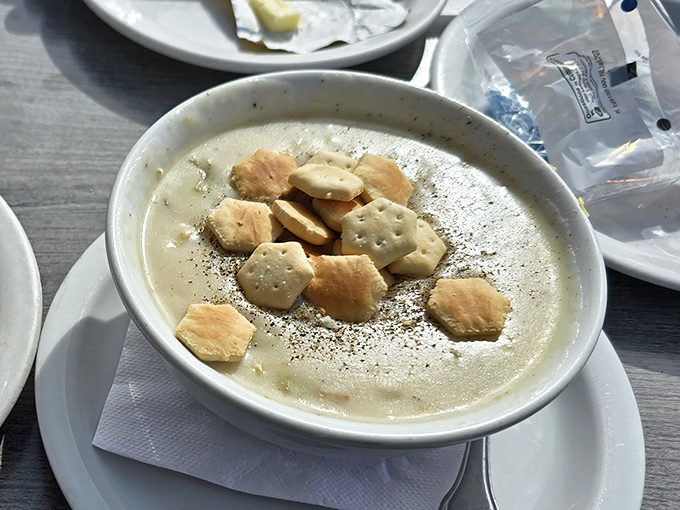 This isn't just clam chowder; it's a creamy bowl of coastal comfort, topped with crackers and ready to warm you from the inside out.