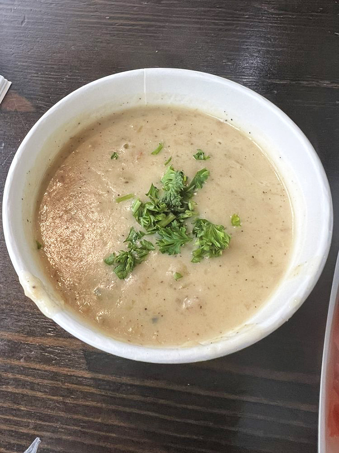 This bowl of clam chowder isn't just soup; it's a creamy ocean hug garnished with fresh herbs and maritime memories.