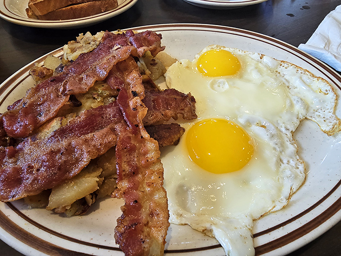 The breakfast of champions isn't what they serve at the Olympics – it's this perfect plate of crispy bacon, home fries, and sunny-side-up eggs.