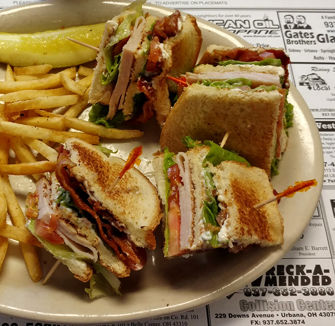 Architecture of deliciousness: perfectly stacked layers of turkey, bacon, and fresh veggies between golden toast triangles that would make Frank Lloyd Wright proud.