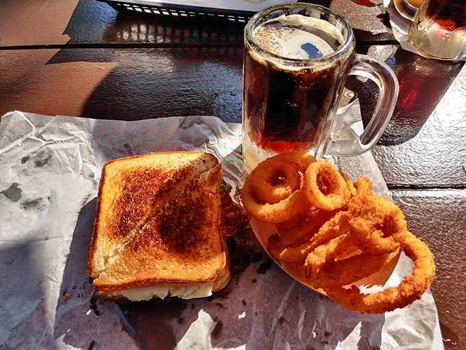 A perfect marriage: Golden-toasted sandwich meets crispy onion rings, with a frosty mug of root beer playing matchmaker. Love at first bite!