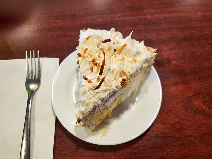 Behold the star attraction: coconut cream pie that would make your grandmother simultaneously proud and jealous. That toasted coconut topping isn't decoration&mdash;it's a crown.