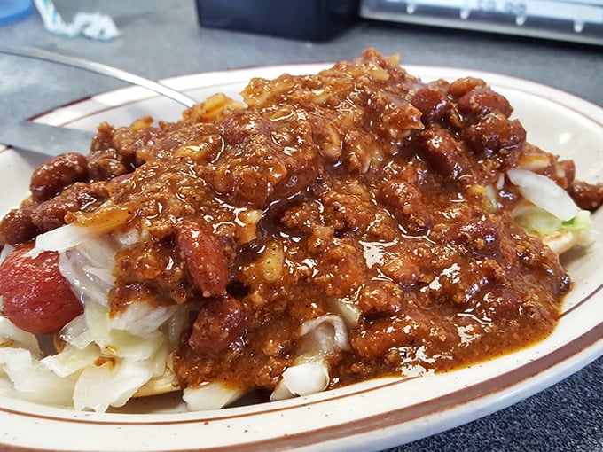 This isn't just a Coney Island &ndash; it's a masterclass in comfort food architecture. Chili cascading over a hot dog with the confidence of a Broadway star.