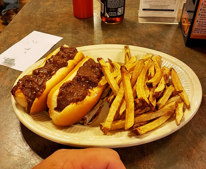 Two perfect coney dogs nestled beside golden fries. This isn't just lunch; it's an edible time machine to when food was honest and deeply satisfying.