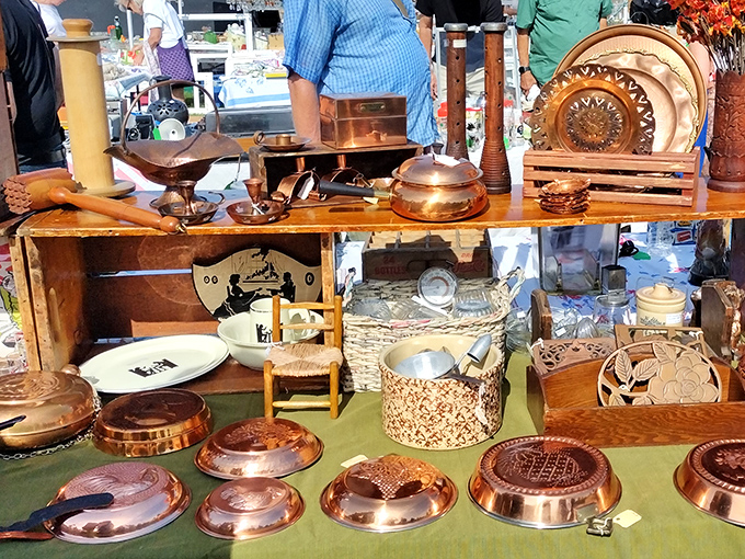 Copper cookware gleams under the market lights, promising both beauty and function. Julia Child would approve of these perfectly patinated pots and pans.