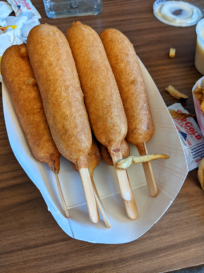 Golden-brown perfection on a stick! These Cozy Dogs aren't just corn dogs&mdash;they're edible monuments to American road trip culture.