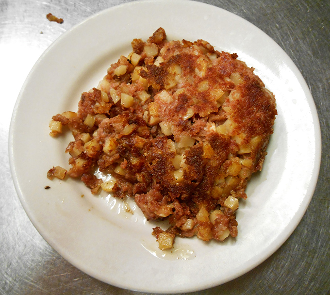 Behold the star attraction&mdash;corned beef hash with the perfect crisp-to-tender ratio. This isn't your sad canned variety; this is breakfast elevated to art form.