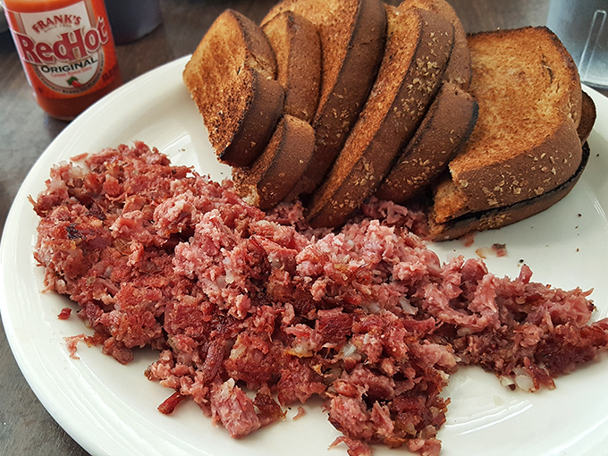 Corned beef hash that deserves its own fan club. Crispy-edged, tender-centered perfection with rye toast that's begging to soak up every last morsel.