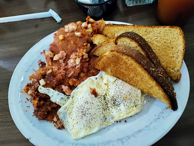 Eggs, perfectly cooked, nestled against a mountain of home fries that somehow manage to be both crispy and tender&mdash;a breakfast paradox worth solving.