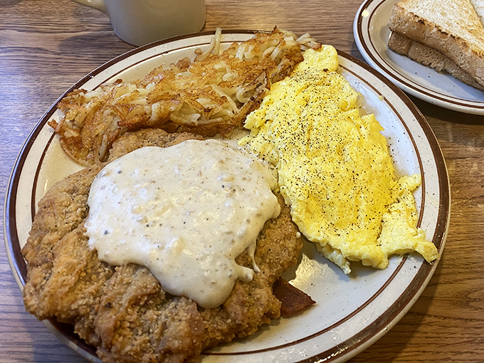 Country fried steak: where crispy, peppery coating meets tender meat in perfect harmony. That gravy could make cardboard taste like a gourmet experience.