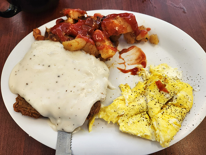 Country fried steak smothered in peppery gravy alongside fluffy scrambled eggs&mdash;proof that breakfast can indeed be the most important meal of the day.