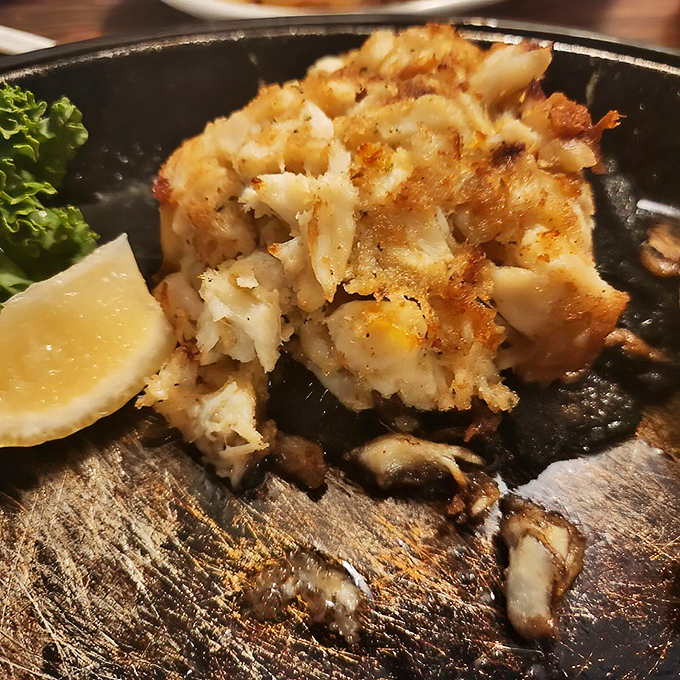 This crab cake isn't just food; it's architecture. Golden-brown exterior giving way to sweet, delicate crabmeat&mdash;the seafood equivalent of striking gold.