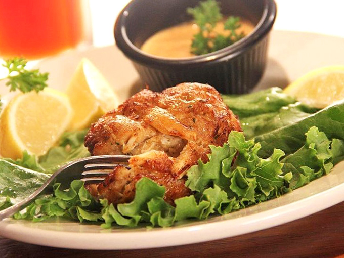 Golden-brown perfection! This crab cake contains so much actual crab meat, it barely needs the bed of lettuce for moral support.