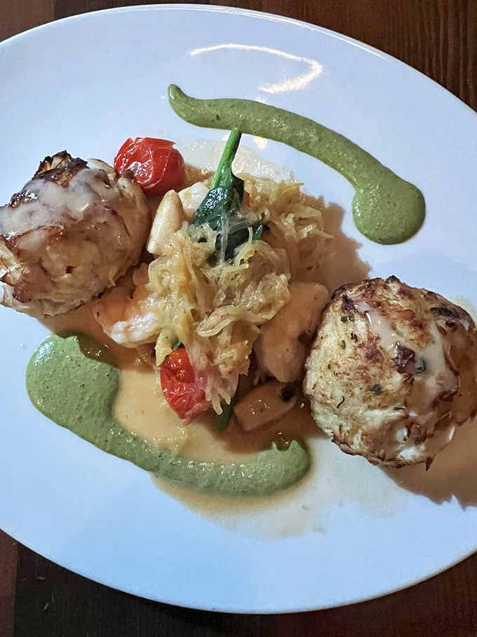 These crab cakes aren't playing around – they've brought backup dancers of sautéed vegetables and an artistic sauce ensemble.