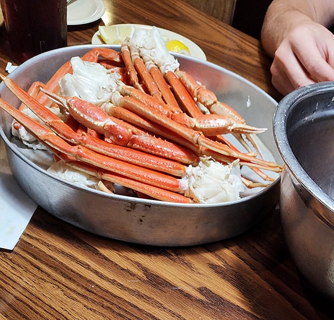 Snow crab legs arranged like nature's perfect puzzle – the kind of dish that justifies wearing that ridiculous plastic bib without a hint of embarrassment.
