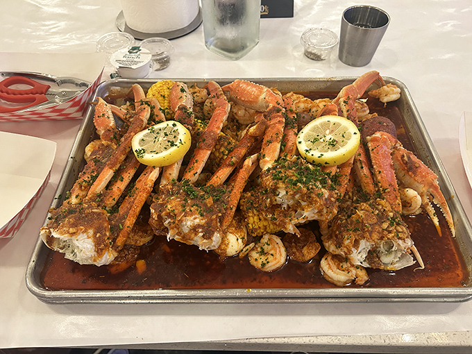 Crab legs so gloriously seasoned they make you question every other seafood meal you've ever had. The scissors nearby hint at the delicious battle ahead.