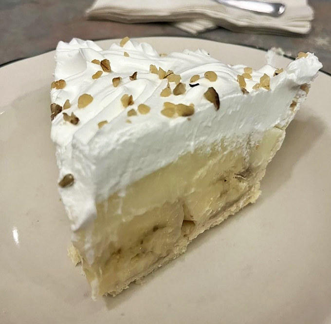 Layer upon heavenly layer of banana and custard topped with clouds of whipped cream. This isn't just dessert; it's therapy without the hourly rate.