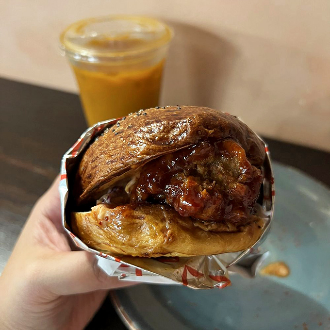 This isn't just a sandwich; it's a masterclass in texture&mdash;crispy chicken embraced by a glossy bun with sauce that demands a napkin strategy.