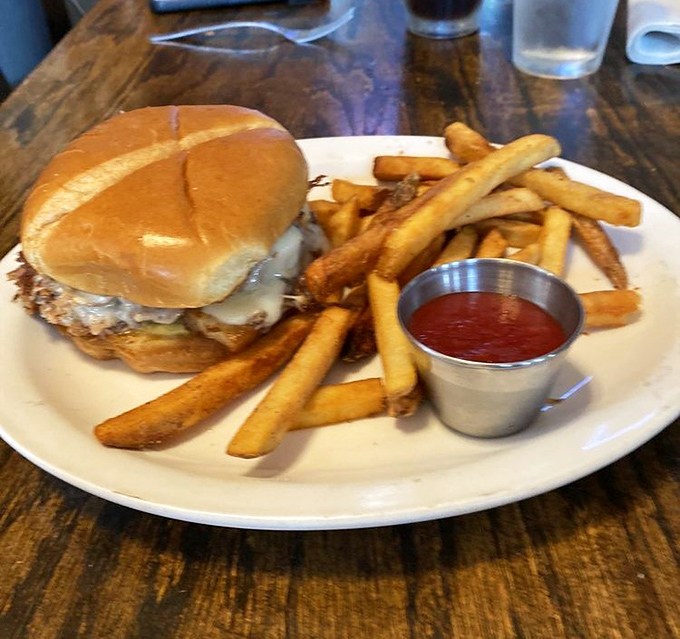 Not just a burger, but a declaration of deliciousness. Those fries look like they've earned their PhD in crispiness.