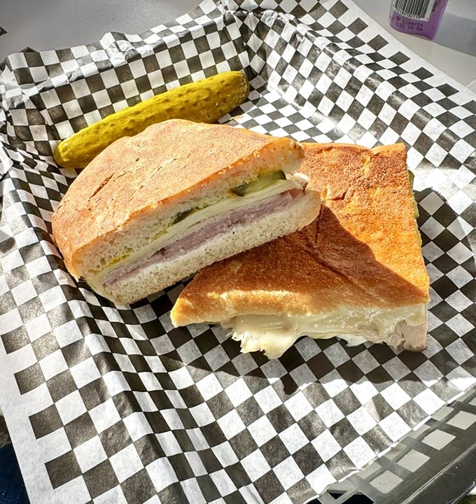 Behold the Cuban sandwich that launched a thousand road trips &ndash; crispy, melty perfection in checkered paper.