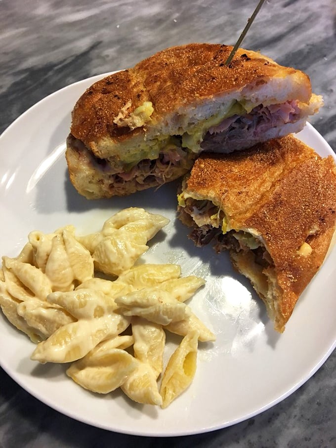 The Cuban sandwich arrives with a side of mac and cheese that's so creamy it should require a permission slip from your cardiologist.