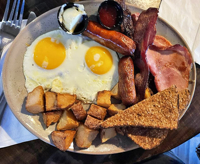 Breakfast perfection on a plate: sunny-side-up eggs, crispy bacon, and golden potatoes. The breakfast equivalent of hitting a royal flush. 